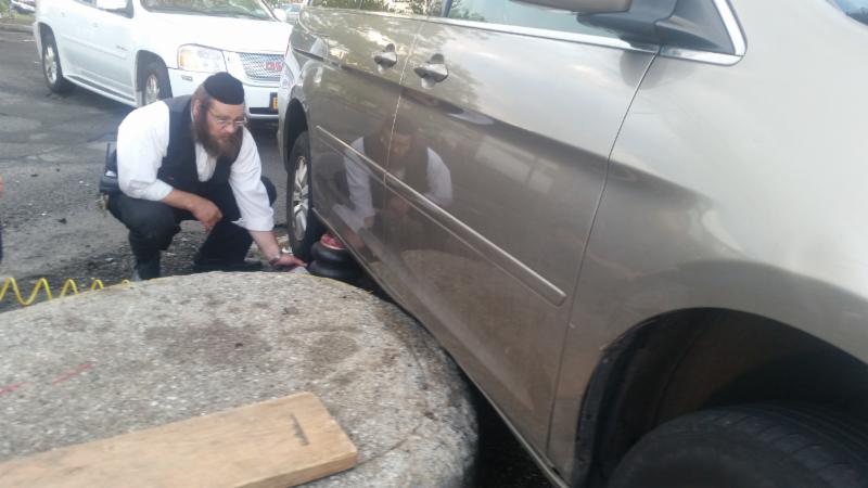 Units operating at the scene of a car stuck on a curb
