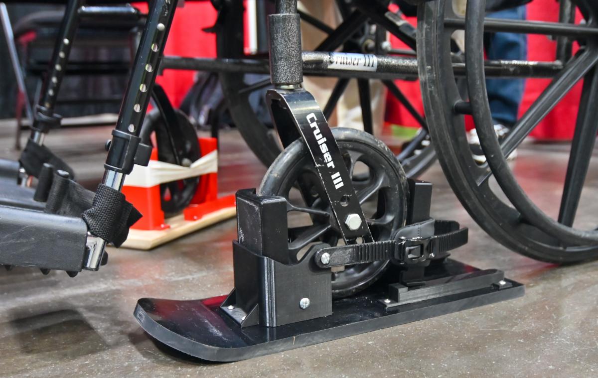 A modified ski boot and a wheelchair with skis
