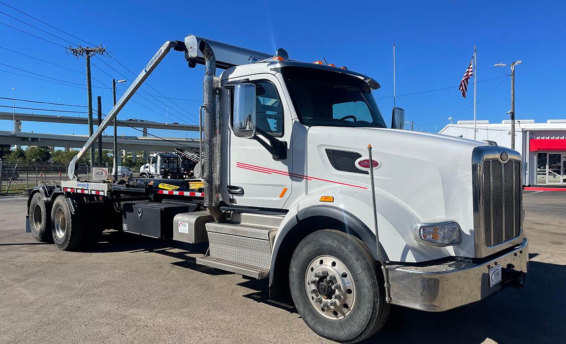 Hook Lifts and Rear Loaders! Drive one home Today!